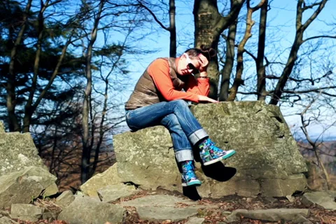 sad woman sitting alone on the rock in t... | Stock Video | Pond5