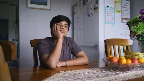 Sad Young Boy Sitting at Dining Table Da... | Stock Video | Pond5