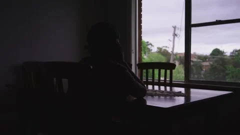 Sad Young Boy Sitting at Dining Table Da... | Stock Video | Pond5