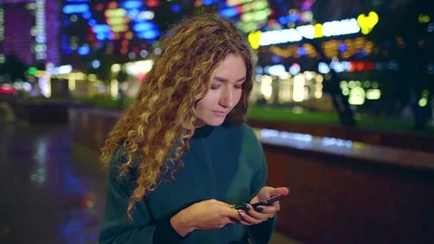 sad young woman is looking around on nig... | Stock Video | Pond5