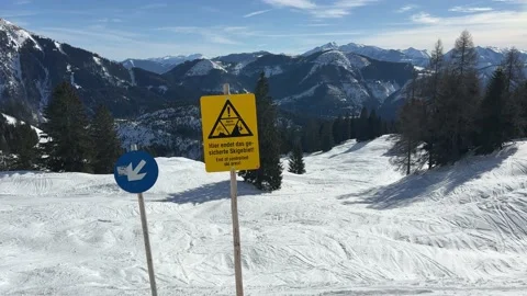 safety warning sign in alpine ski resort | Stock Video | Pond5