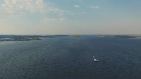 sailboat sails in the distance visible s... | Stock Video | Pond5