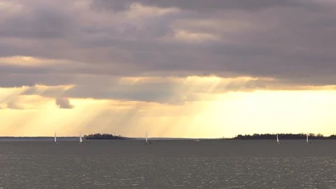 Sailboats dot the ocean under golden sun... | Stock Video | Pond5