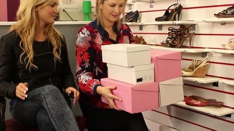 Sales Clerk / Assistant brings some shoe... | Stock Video | Pond5