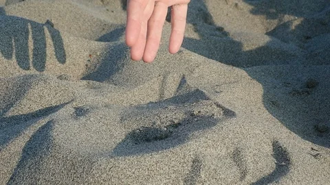 sand falling from hand sand coming down ... | Stock Video | Pond5