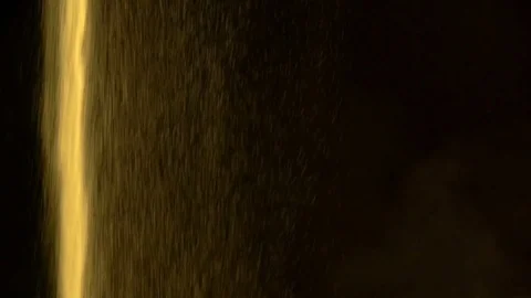 Sand falling in slow motion on dark blac... | Stock Video | Pond5