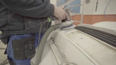 sanding a car bumper with an orbital san... | Stock Video | Pond5
