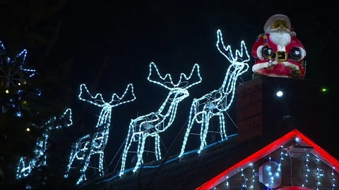 Santa and reindeer lit up on a garage ro... | Stock Video | Pond5
