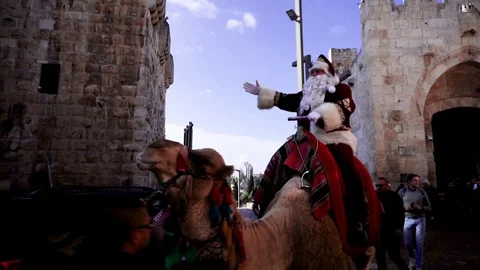 Santa on a camel spreads cheers and deli... | Stock Video | Pond5