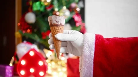 Santa Claus lifting up an ice cream cone... | Stock Video | Pond5