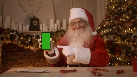 Santa Claus showing mobile phone with gr... | Stock Video | Pond5