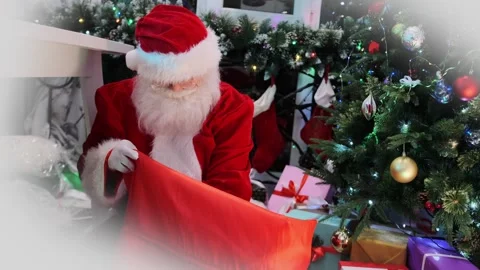 Santa Claus stuffing present bag with pi... | Stock Video | Pond5