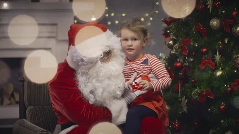 Santa Claus talking with little girl sit... | Stock Video | Pond5