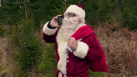 Santa Claus talking on phone and laughin... | Stock Video | Pond5