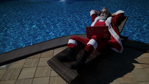 Santa sunbathing at swimming pool funny ... | Stock Video | Pond5