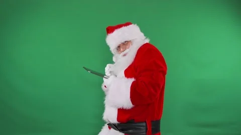 Santa takes notes on his tablet with a g... | Stock Video | Pond5
