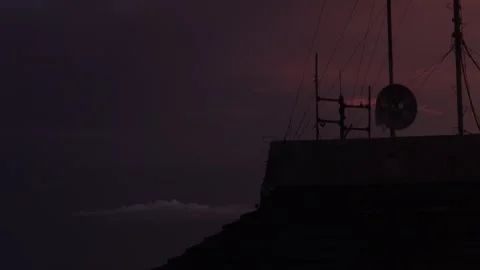 Satellite dish silhouette while lightnin... | Stock Video | Pond5