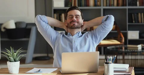 Satisfied employee relaxing at office de... | Stock Video | Pond5