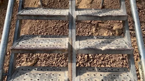 scaffold stair installed on a dirt slope... | Stock Video | Pond5