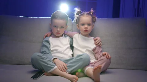 Scared hugging brother and sister watchi... | Stock Video | Pond5