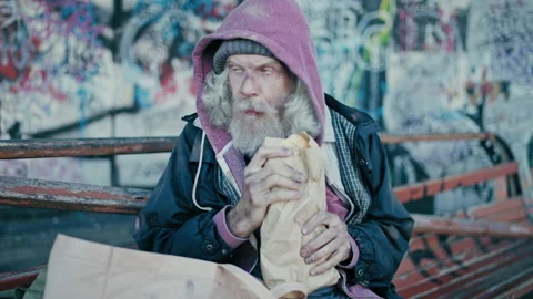 Scared male beggar eating bread, sitting... | Stock Video | Pond5