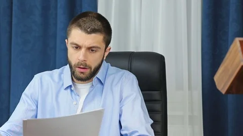 Scared man eating paper slowly | Stock Video | Pond5