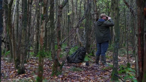 A scared man in a forest drinking someth... | Stock Video | Pond5