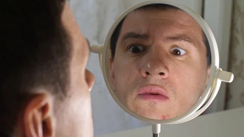 Scared man with pimple in a front of mir... | Stock Video | Pond5