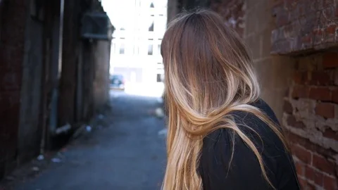 Scared woman in an alley making an emerg... | Stock Video | Pond5