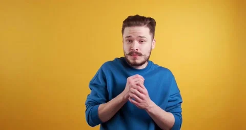 Scared young man looking around on yello... | Stock Video | Pond5