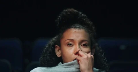 A scared young woman at the movie theatr... | Stock Video | Pond5