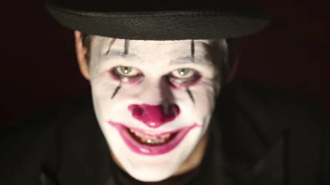 Scary clown looks at the camera and laug... | Stock Video | Pond5