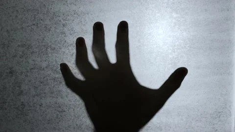 A scary hand in shadow slamming against ... | Stock Video | Pond5