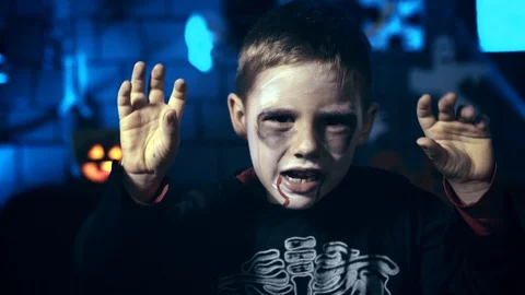 Scary little boy wearing skull makeup fo... | Stock Video | Pond5