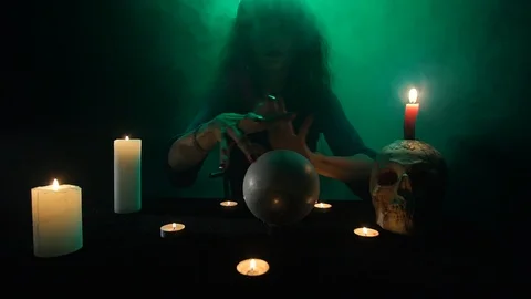 Scary witch in green smoke, conjuring on... | Stock Video | Pond5
