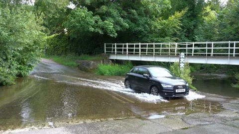 Scene of a car driving through a ford in... | Stock Video | Pond5