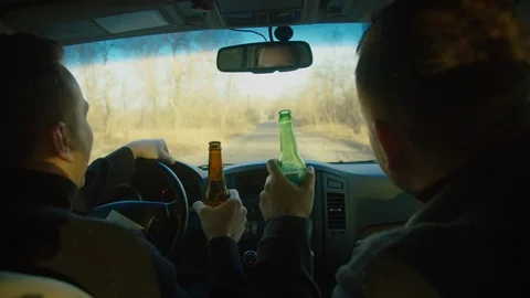 Scene of two men ride in a car with bott... | Stock Video | Pond5
