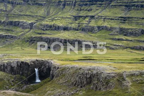 Photograph: Scenic view of Folaldafoss waterfall and landscape, Eastern ...