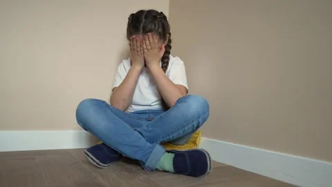 School-age child is sad in corner of roo... | Stock Video | Pond5