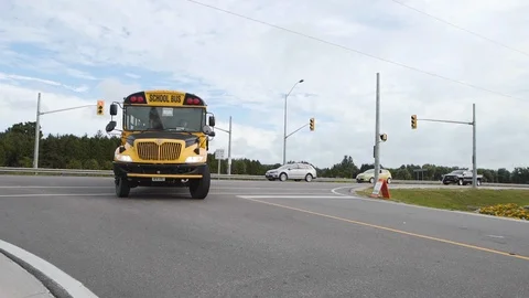 School bus making a left turn on a city ... | Stock Video | Pond5