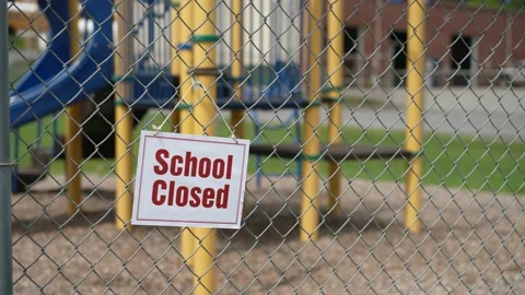 School Closed sign on fence in front of ... | Stock Video | Pond5