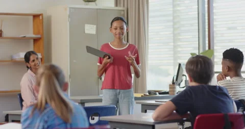 In school, girl presenting with tablet i... | Stock Video | Pond5