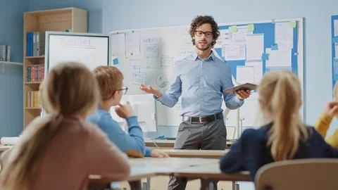 School Teacher Show to Classroom how Ren... | Stock Video | Pond5