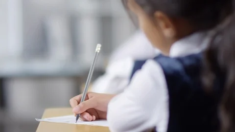 Schoolgirl Filling in Boxes on Test Repo... | Stock Video | Pond5