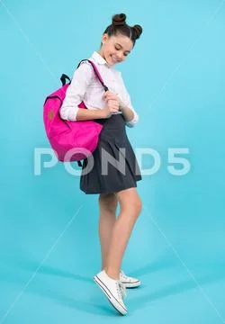 Schoolgirl in school uniform with school bag. Teenage girl student on ...