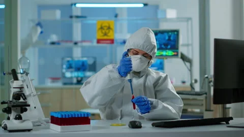 Science technician in ppe suit using mic... | Stock Video | Pond5