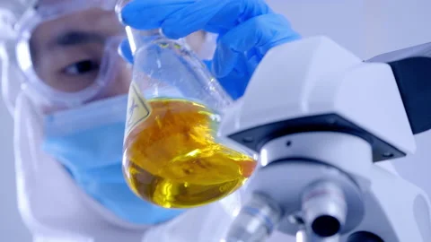 Scientist checking a liquid in a test tu... | Stock Video | Pond5