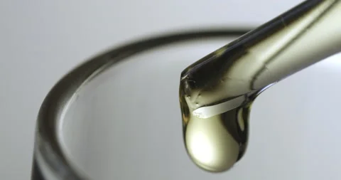 Scientist chemist dripping engine oil fr... | Stock Video | Pond5