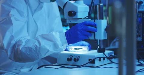 Scientist examining sample with a micros... | Stock Video | Pond5