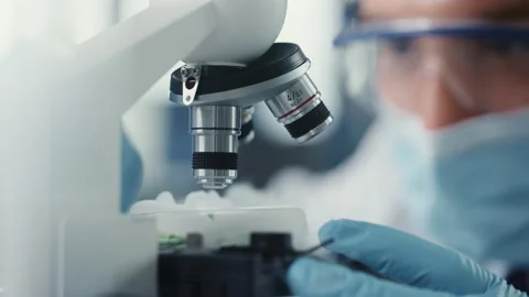 Scientist Mixing Chemicals Under Microsc... | Stock Video | Pond5